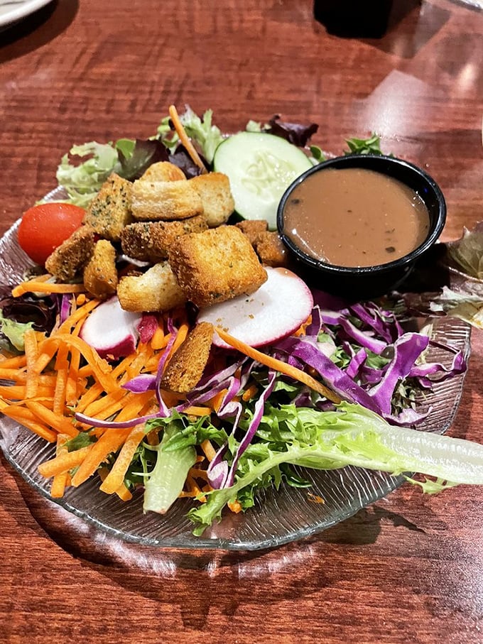 A garden salad that actually deserves the name "garden"—vibrant, fresh, and colorful enough to make you momentarily forget about those garlic mussels. Almost.