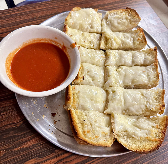 Garlic bread with cheese—the unsung hero of Italian-American menus. Simple, perfect, and somehow always exactly what you needed all along.