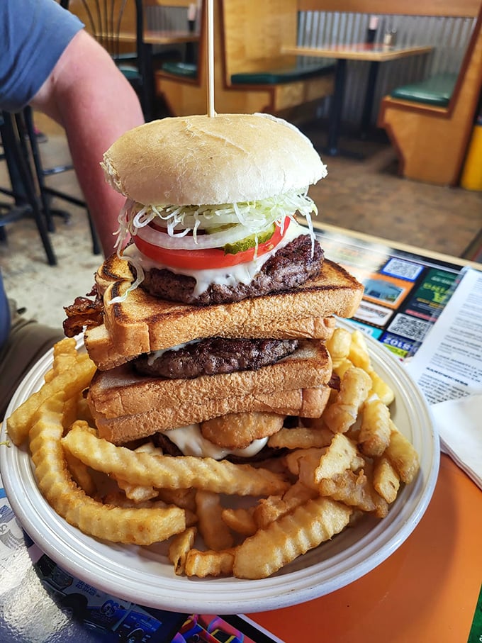 This towering burger creation isn't just a meal, it's a challenge—a delicious Jenga tower of beef, cheese, and toast that dares you to find your strategy.