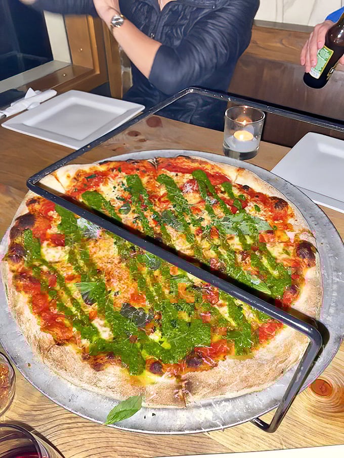 This isn't just a pizza with basil – it's edible modern art where vibrant green stripes create a visual feast before the actual feast begins.