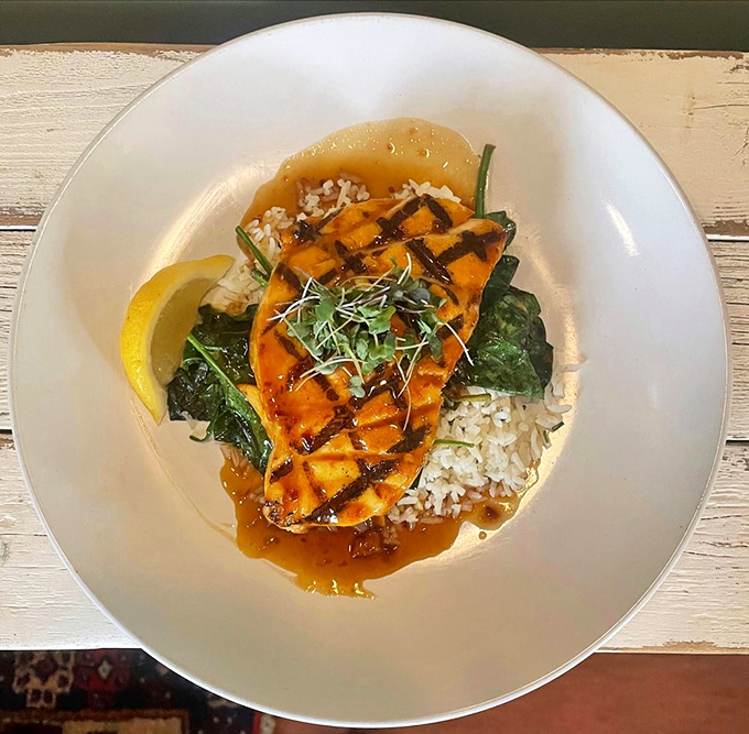 Grilled swordfish resting on a bed of rice and greens—the kind of simple, perfect plate that reminds you why humans invented cooking in the first place.
