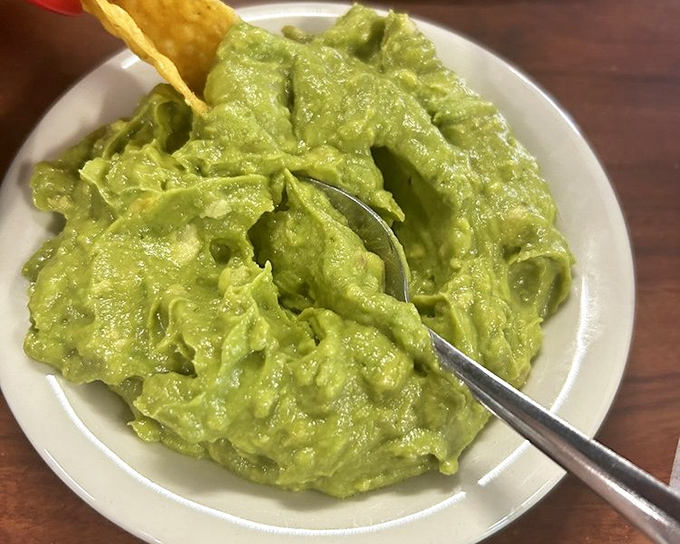 This guacamole deserves its own area code – creamy yet chunky, with just enough lime to make your taste buds do the cha-cha. The chip is merely a delivery system.