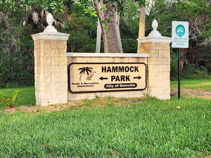 Hammock Park's entrance beckons with the subtle suggestion that perhaps the best Florida souvenir is simply an afternoon spent in tranquil, leafy silence.