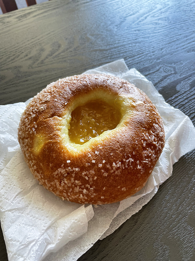 Behold the crown jewel – a sugar-crusted pastry with a golden center of fruit preserves that glistens like a stained glass window in a cathedral of carbs.