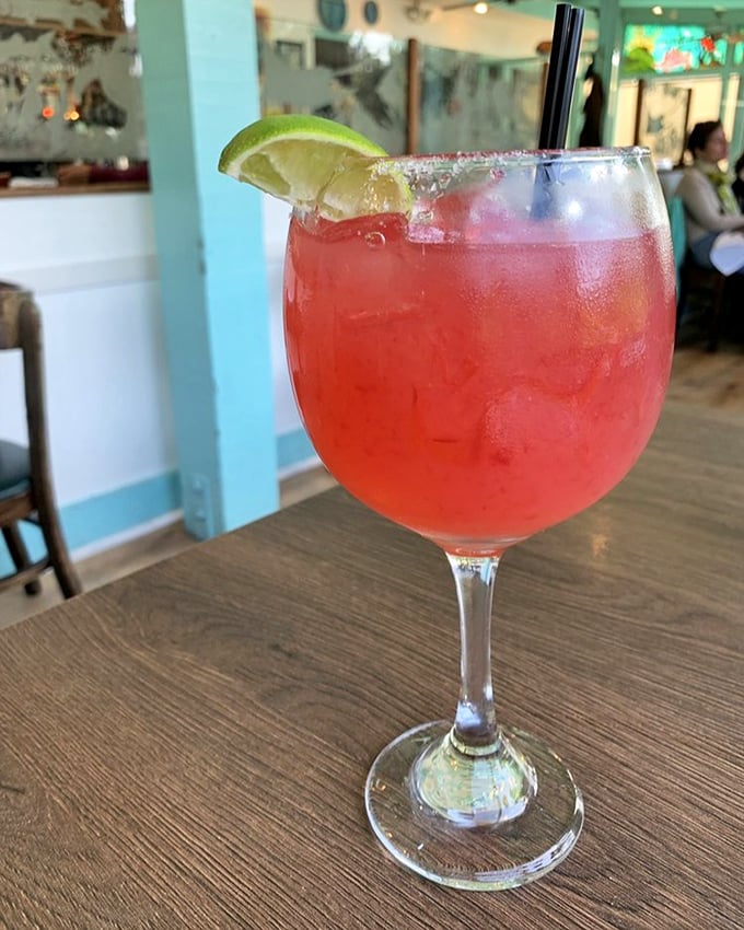 A vibrant hibiscus margarita that's basically vacation in a glass. The salt rim isn't just for show—it's the perfect counterpoint to the sweet-tart symphony.