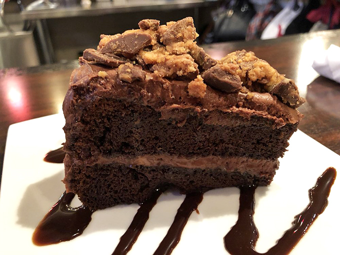 This isn't just chocolate cake—it's a monument to decadence. Peanut butter cups and fudge sauce turn dessert into an experience worth saving room for.