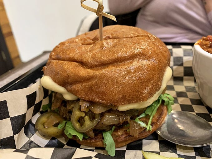 A towering house burger that defies gravity and expectations—proof that vegetarian doesn't mean settling for less.