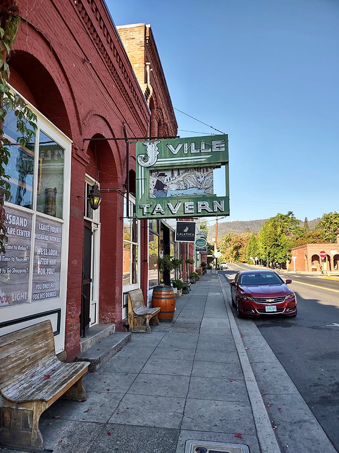 J'Ville Tavern's vintage sign promises cold beer and warm conversation—the kind of place where strangers become friends over local brews and shared stories.