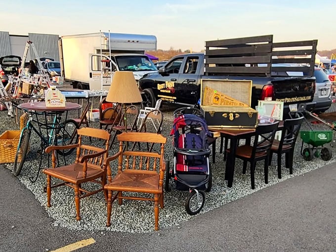 The furniture migration in its natural habitat. Wooden chairs, tables, and lamps gather at the edge of the asphalt, hoping to catch the eye of passing shoppers.