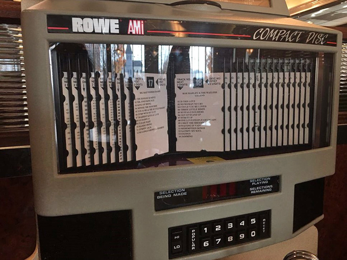 The jukebox—a musical time machine offering everything from Sinatra to Springsteen. Three quarters and suddenly everyone's singing along to "Sweet Caroline."