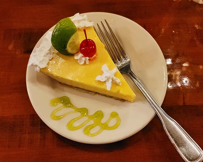 Key lime pie that hits all the right notes—tangy, sweet, and creamy with a decorative swirl that says, "Yes, we care about dessert too."