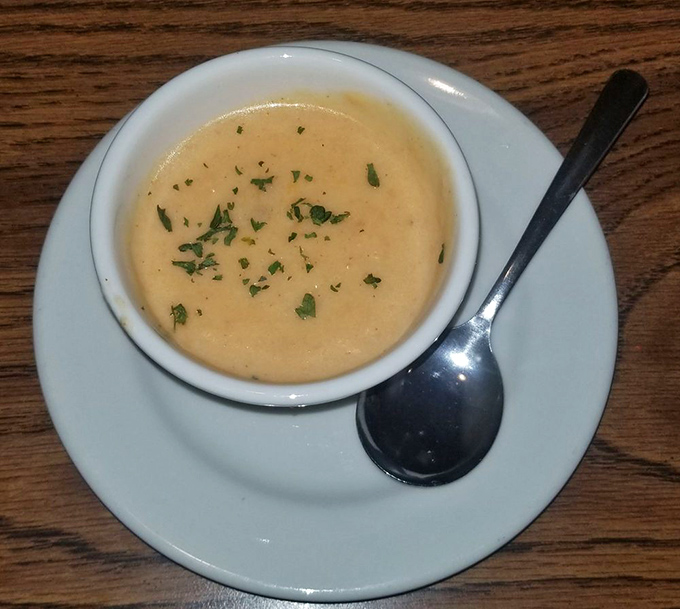 The lobster bisque, creamy and flecked with herbs, is like a warm New England hug in a bowl – comfort food with an upscale accent.