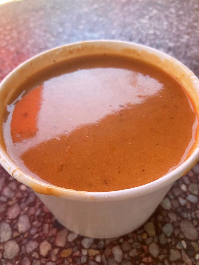 This lobster bisque isn't just soup—it's liquid luxury in a humble cup. The color alone tells you there's been no cutting of corners, only shellfish transformed into silky perfection.