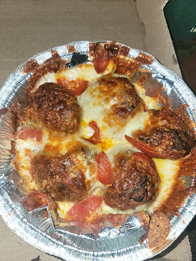 These aren't just meatballs—they're flavor planets orbiting in a galaxy of melted cheese and sauce. One small step for man, one giant leap for your taste buds.