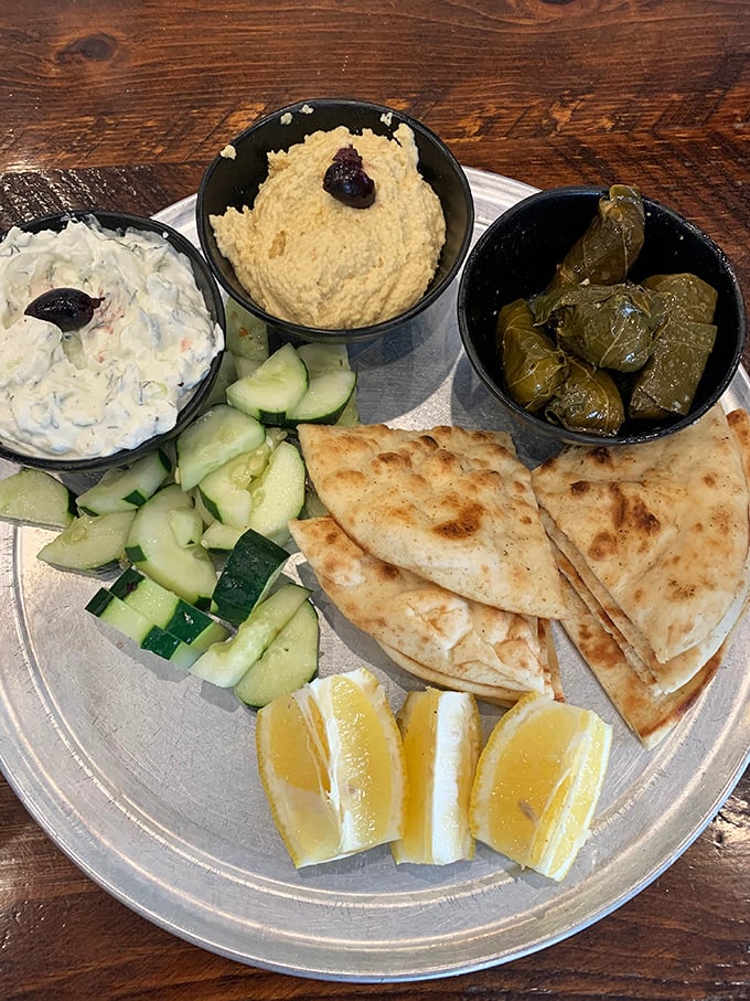 The meze sampler—for when you want a little bit of everything wonderful. Hummus, tzatziki, dolmades, and pita create a choose-your-own-adventure of flavors.