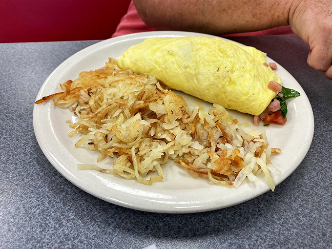 The omelet: breakfast's most accommodating dish. This fluffy yellow masterpiece neighbors hash browns that achieved the perfect crisp-to-tender ratio.
