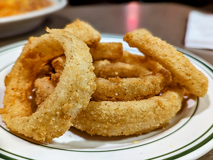 These aren't just onion rings; they're golden halos of crispy perfection that make you wonder why anyone would ever settle for the frozen kind again.