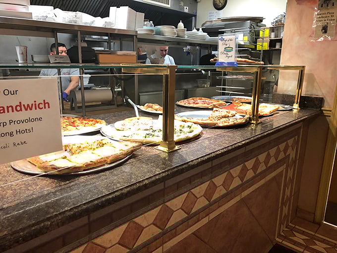 Pizza paradise in plain view—watching these pies waiting to meet their destiny might be the most delicious form of anticipation. 