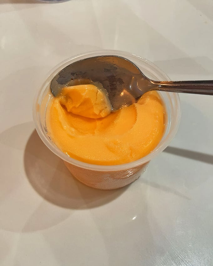 A cup of orange sherbet—the perfect palate cleanser between buffet rounds or the refreshing finale to an epic feast.