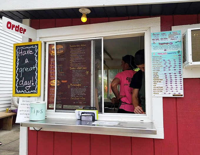The ordering window—where dreams are spoken aloud and returned as paper-wrapped packages of burger joy just minutes later.