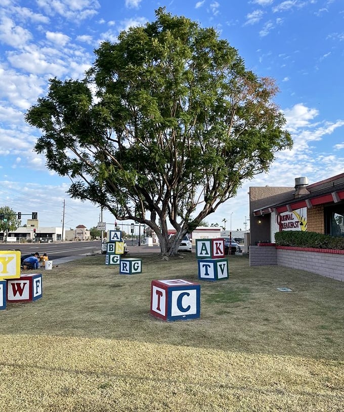 Giant alphabet blocks scattered across the lawn—a playful reminder that breakfast joy is elementary at Original Breakfast House.