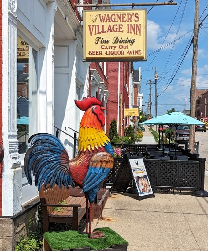 That magnificent rooster statue stands guard outside, a colorful sentinel announcing to all: serious chicken business happens here.