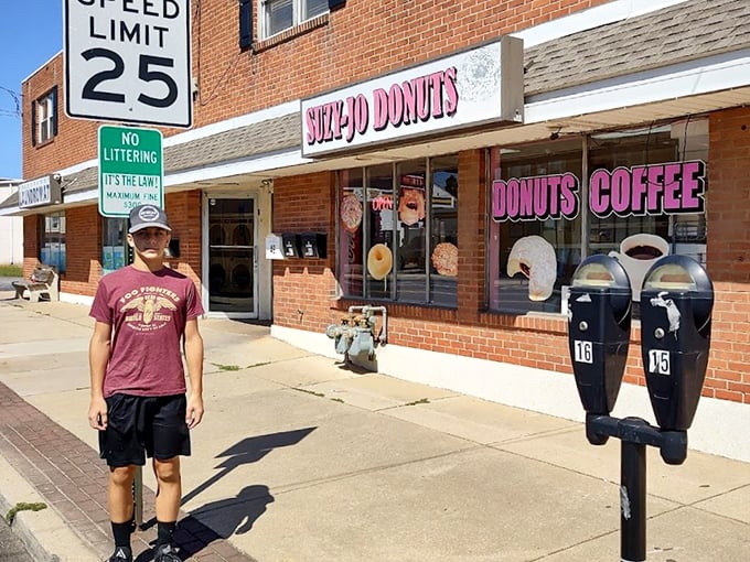 Outside Suzy-Jo's, where the speed limit sign might as well read "25 mph—unless you're rushing home to enjoy your donuts while they're fresh."