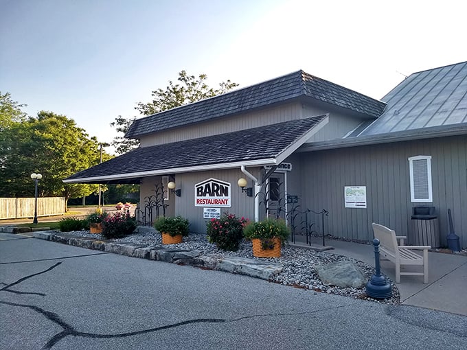 As evening approaches, The Barn Restaurant's exterior takes on a golden glow, beckoning hungry travelers with the promise of home-cooked perfection.