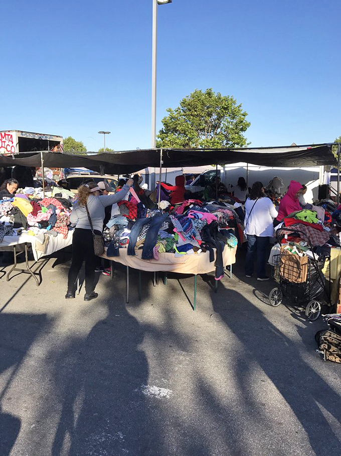 The clothing mountain challenge – shoppers digging for deals in piles promising fashion gold for those willing to search.