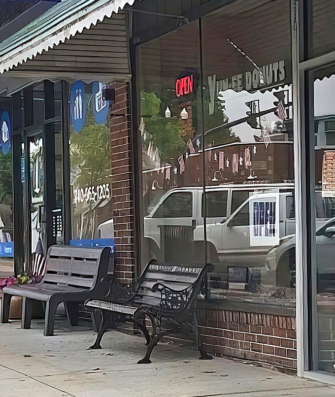 That bench outside isn't just seating—it's a front-row ticket to the simple pleasure of enjoying a donut while watching small-town Ohio wake up.