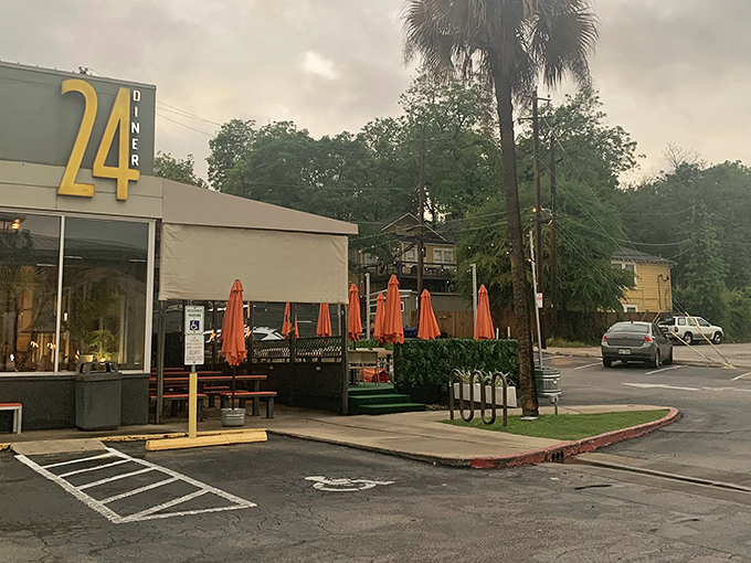 The outdoor patio waits under palm trees and orange umbrellas—a perfect spot for people-watching with your chicken and waffles.