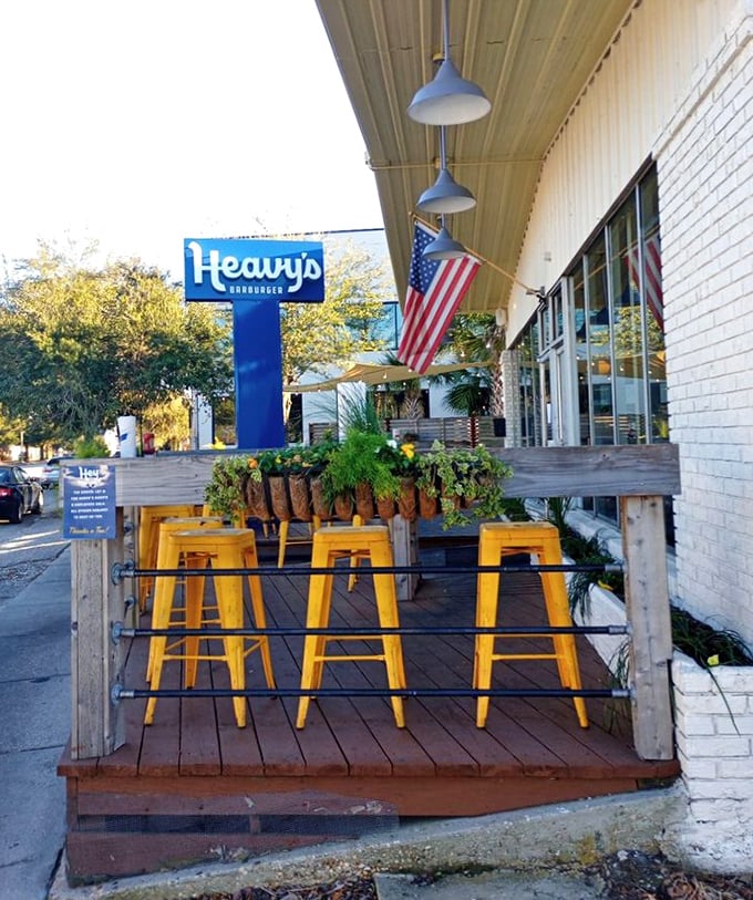 Yellow stools waiting for you like old friends. The outdoor patio at Heavy's offers fresh air with your fresh patty.