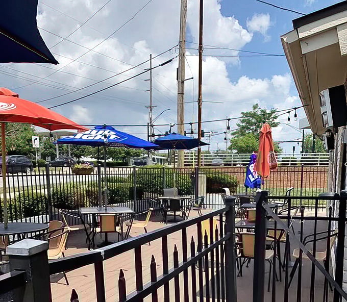 The patio's simple charm invites you to enjoy your pizza beneath blue skies and beer umbrellas—because pasta tastes even better with a side of fresh air.
