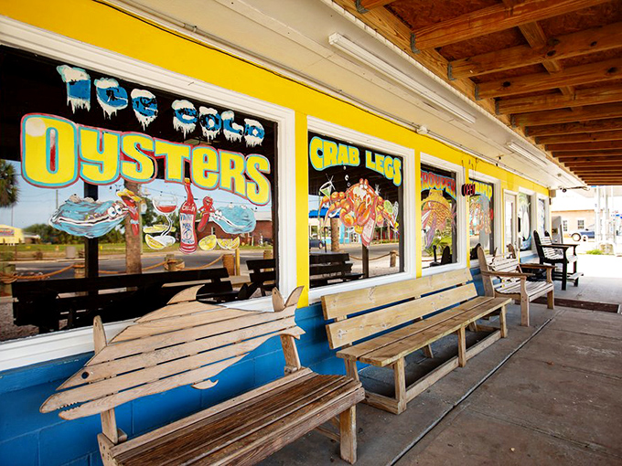 The outdoor patio with its colorful window art and wooden benches offers a perfect spot to slurp oysters while soaking up that Panama City sunshine.