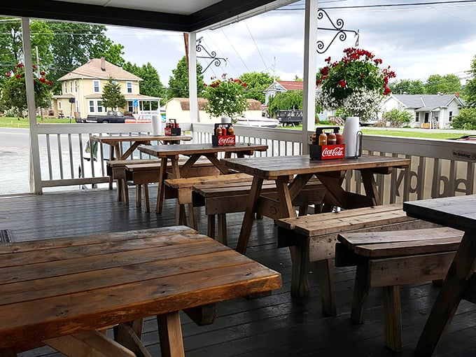 The covered porch offers a front-row seat to barbecue bliss—these picnic tables have witnessed countless food-induced moments of pure happiness.