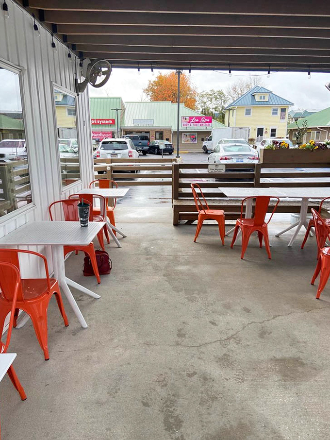 Orange chairs pop against concrete in this outdoor seating area—a perfect perch for people-watching while devouring the day's catch.