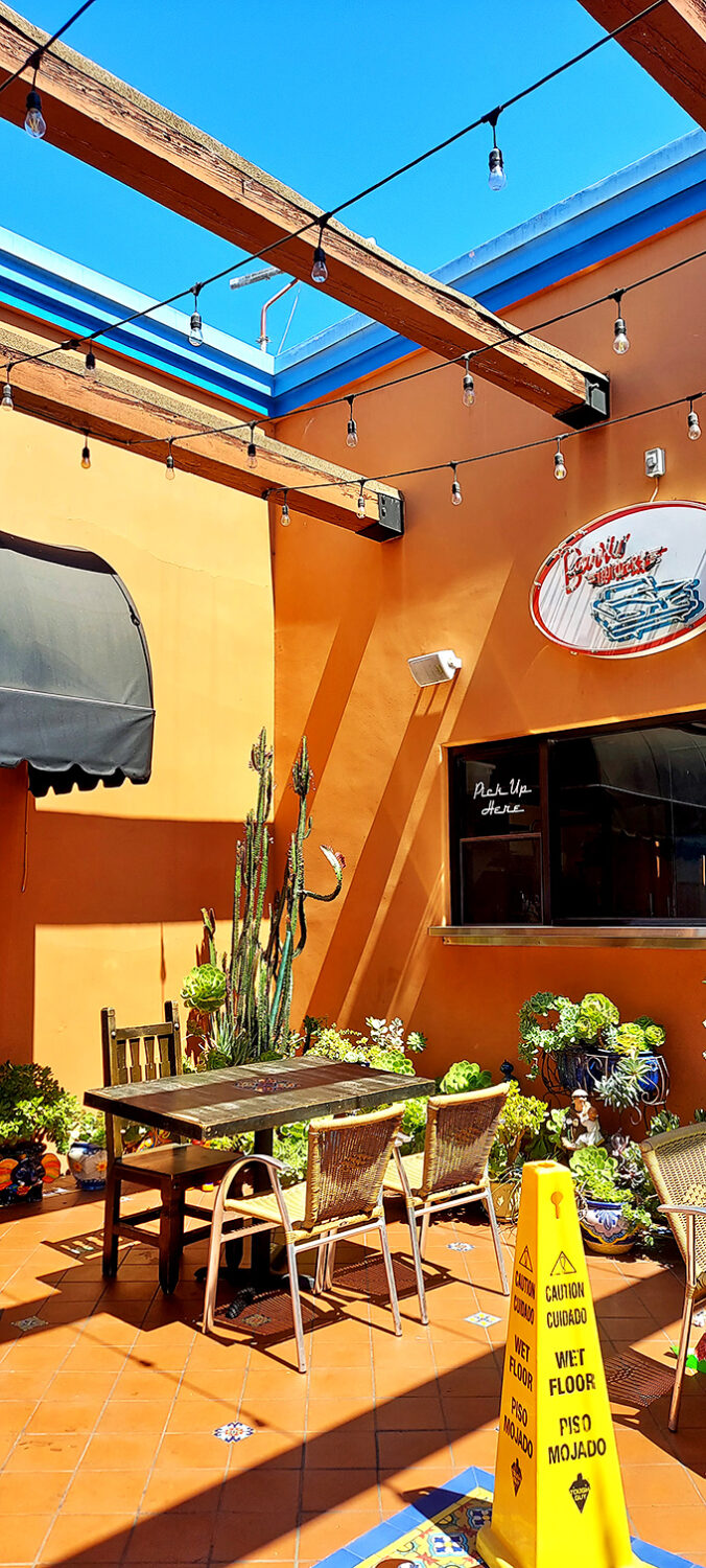 The outdoor patio, where string lights dance overhead and terracotta tiles underfoot create the perfect stage for enjoying your bakery treasures al fresco.