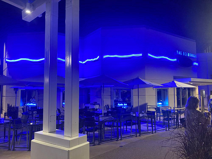 As evening falls, The Oceanaire's exterior glows with cool blue light—like an underwater grotto beckoning you in from Orlando's heat.