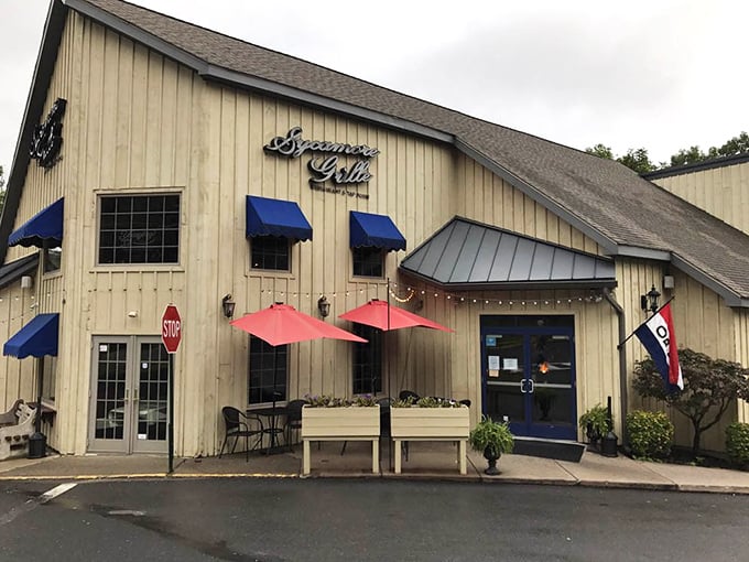 The inviting exterior complete with outdoor dining space – your gateway to discovering Delaware Water Gap's hidden gem.