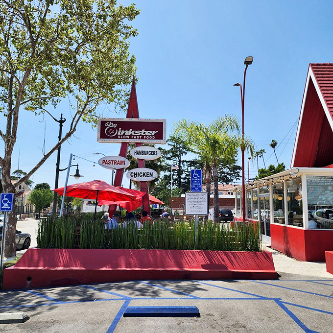 The Oinkster's retro sign promises three simple pleasures—pastrami, hamburgers, and chicken—delivered with extraordinary care and flavor.