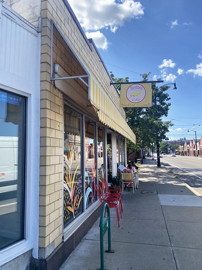 The sidewalk view reveals Butter Cafe's place in the neighborhood tapestry – a sunny yellow landmark where Dayton comes to start the day right.