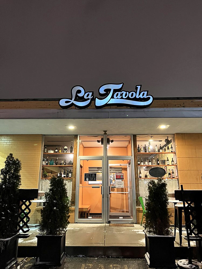 As evening falls, La Tavola's sign glows like a beacon for hungry travelers. The Italian equivalent of "You've reached your destination."