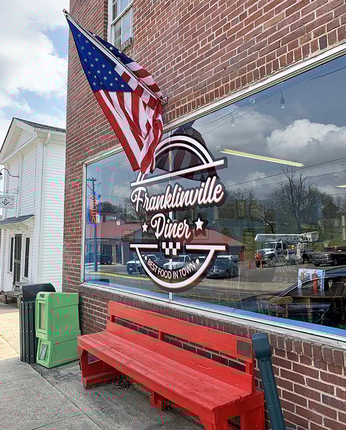 That red bench and proud American flag aren't just decorations—they're a promise that inside these brick walls, tradition still matters.