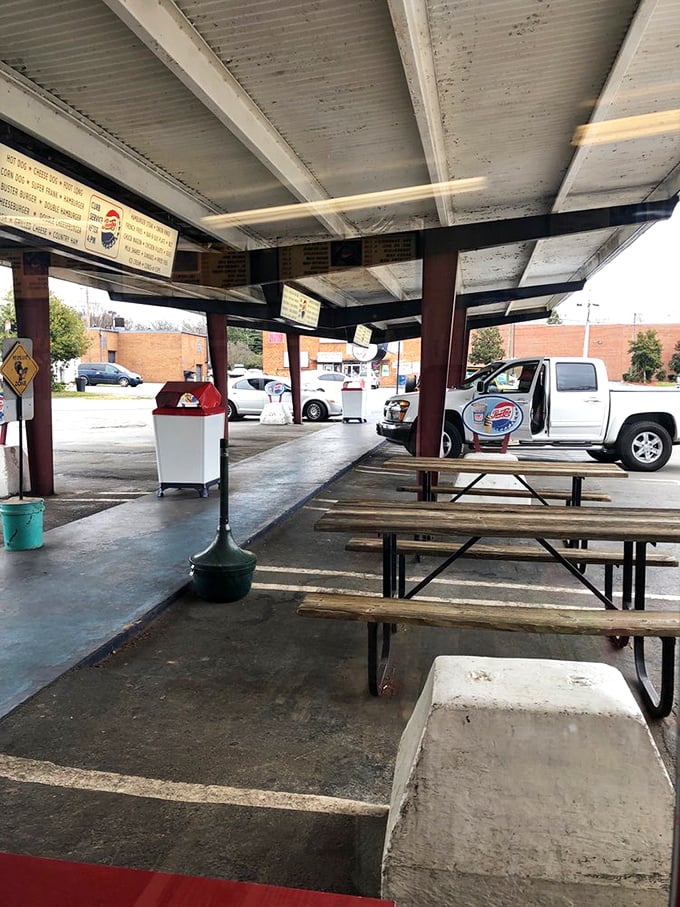 These picnic tables have witnessed first dates, family reunions, and solo lunches—each wooden slat holding decades of Winston-Salem stories and ketchup stains.