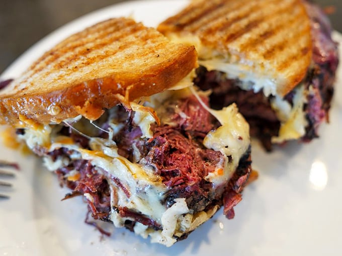Not a sandwich, but a cross-section of perfection. The strategic layering of pastrami and cheese creates flavor architecture worthy of study.