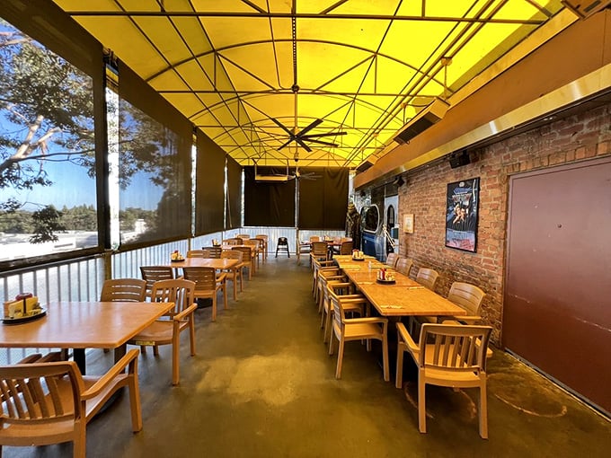The outdoor patio scene—yellow canopy overhead, wooden tables below, and brick walls creating the perfect setting for your next breakfast sequel.