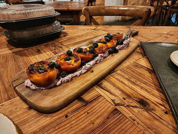 Grilled peaches that prove dessert doesn't need chocolate to be memorable. Sweet, smoky fruit with fresh berries – summer's greatest achievement on a wooden plank.