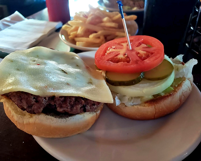 A burger that proves simplicity is the ultimate sophistication: juicy beef, melted cheese, fresh vegetables, and a bun that knows its supporting role perfectly.