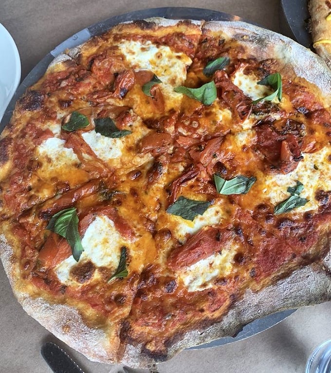 Wood-fired perfection with a blistered crust that tells tales of proper heat. This Margherita pizza doesn't need to shout—its simple, perfect flavors speak volumes.