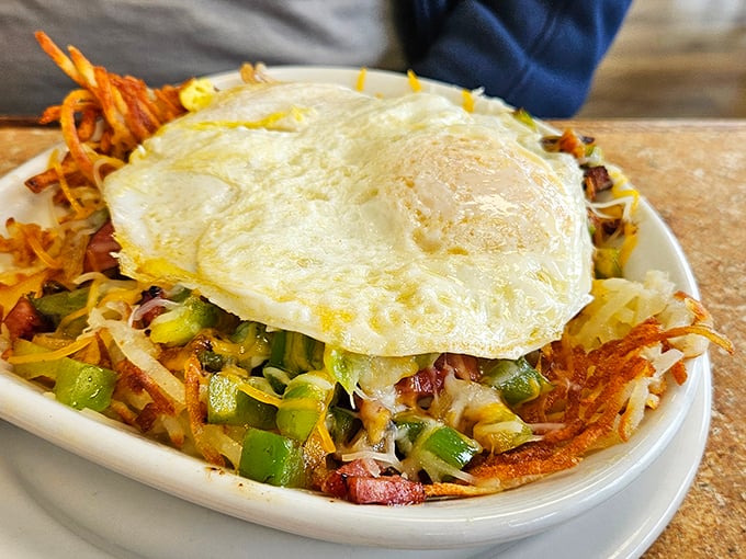 Breakfast hash topped with a perfect sunny-side-up egg—the morning masterpiece that makes hitting the snooze button worth it.